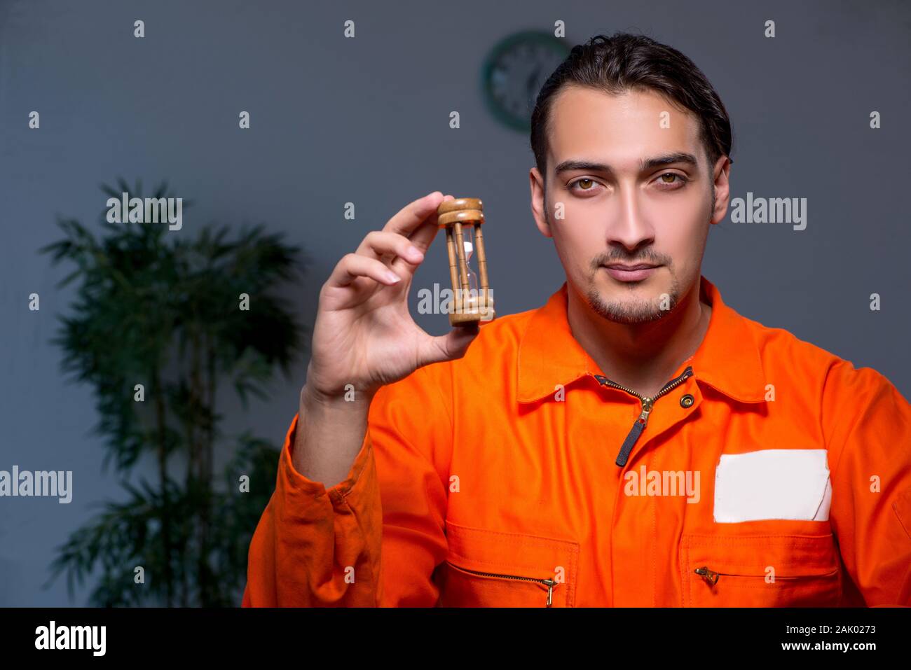 The young convict man sitting in dark room Stock Photo - Alamy