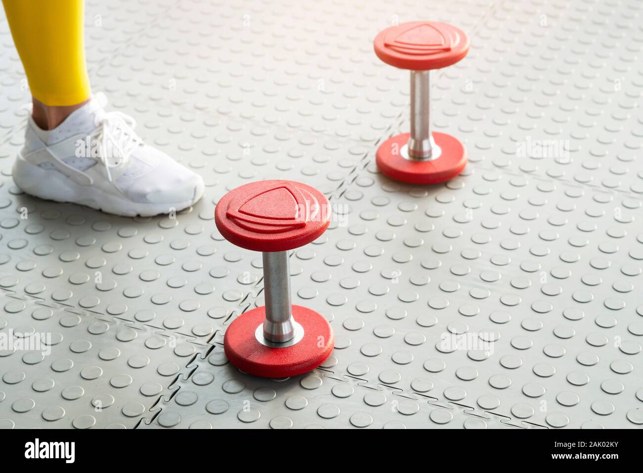 dumbbell exercise weights standing on the floor in gym Stock Photo - Alamy