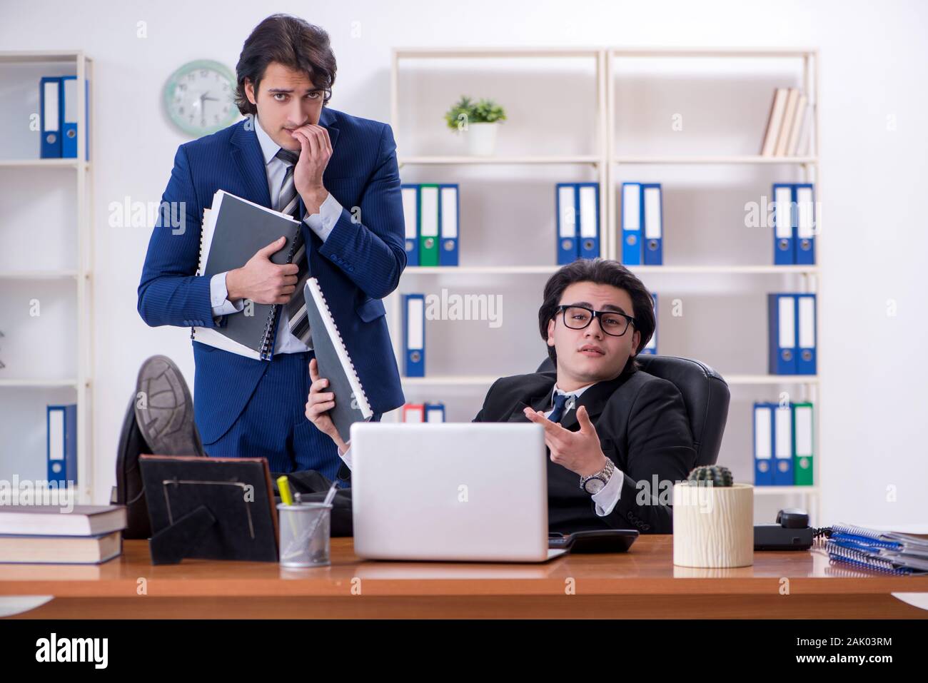 The boss and his male assistant working in the office Stock Photo - Alamy