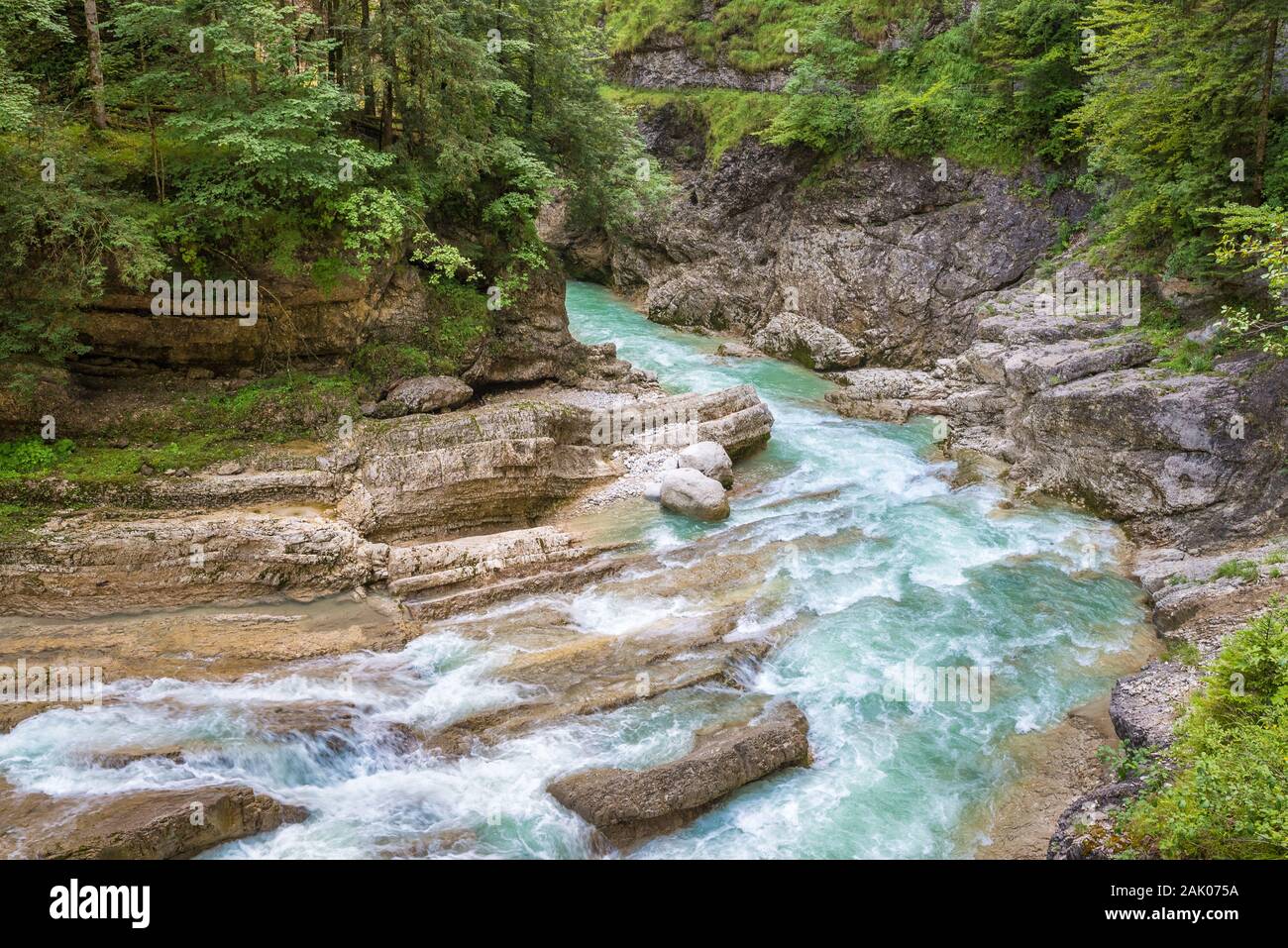 Wild blue colored water stream in a gorge in the Alps Stock Photo - Alamy