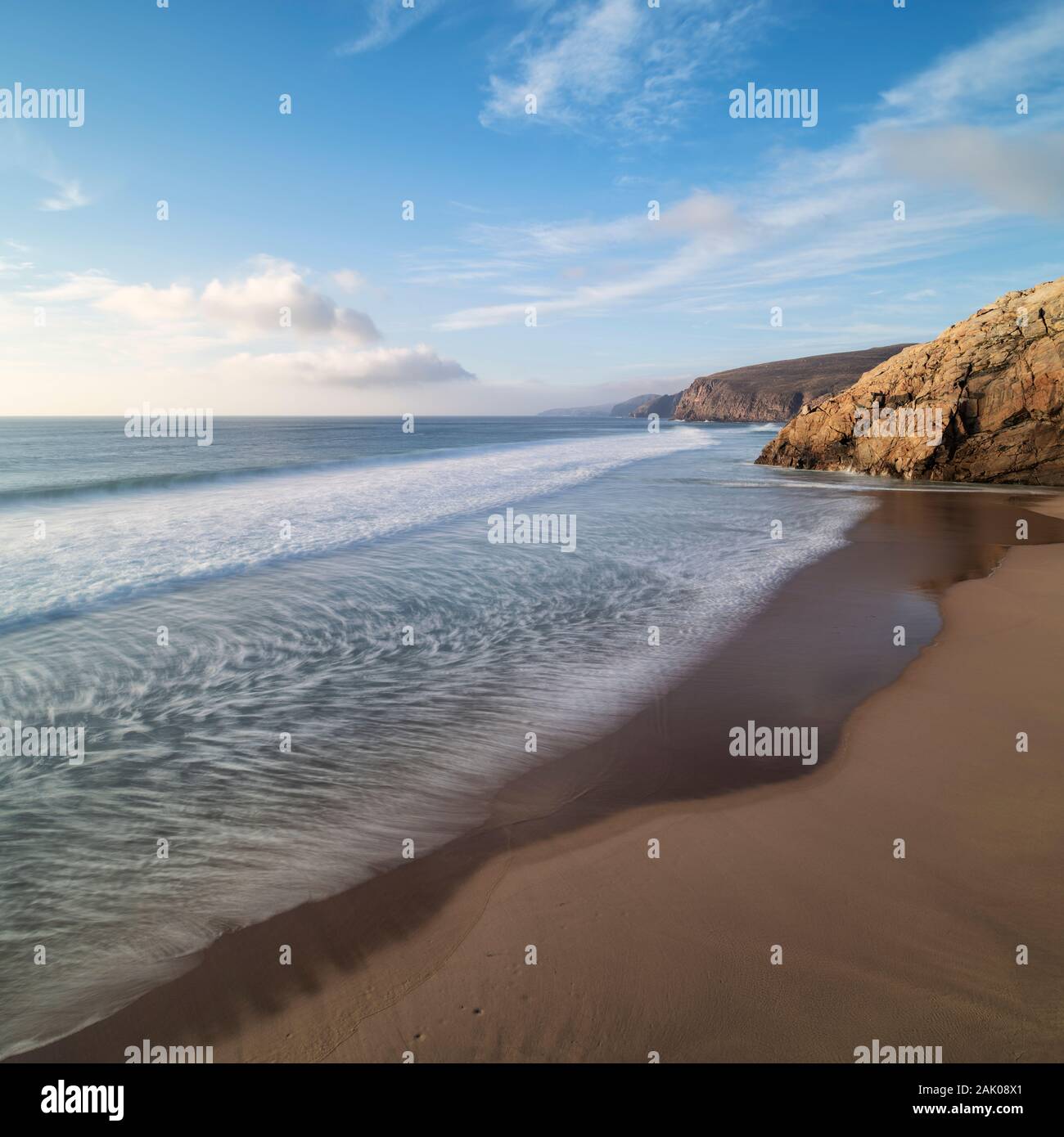Waves wash over sandy shoreline at Isolated Sandwood bay beach ...
