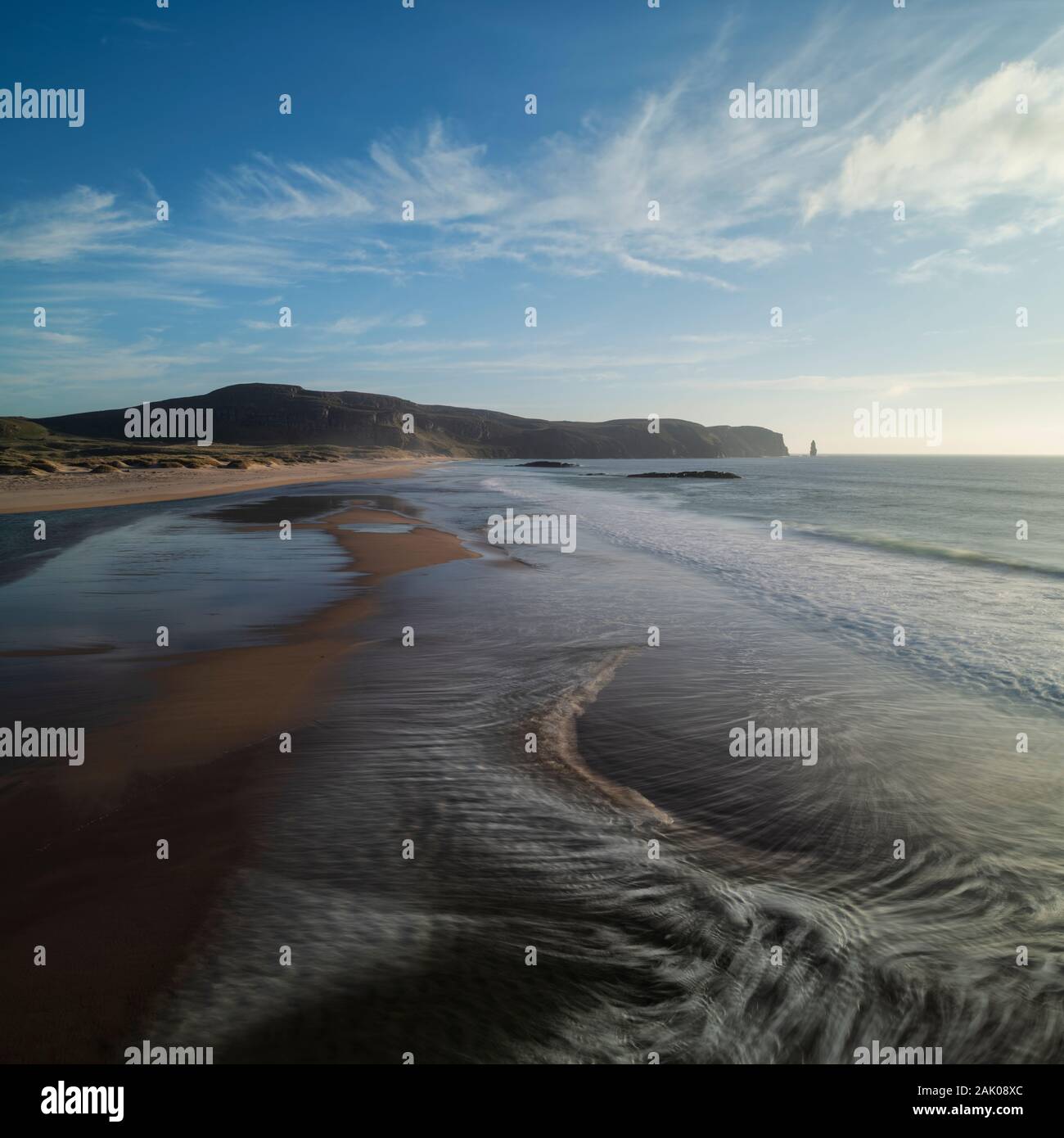 Waves wash over sandy shoreline at Isolated Sandwood bay beach ...