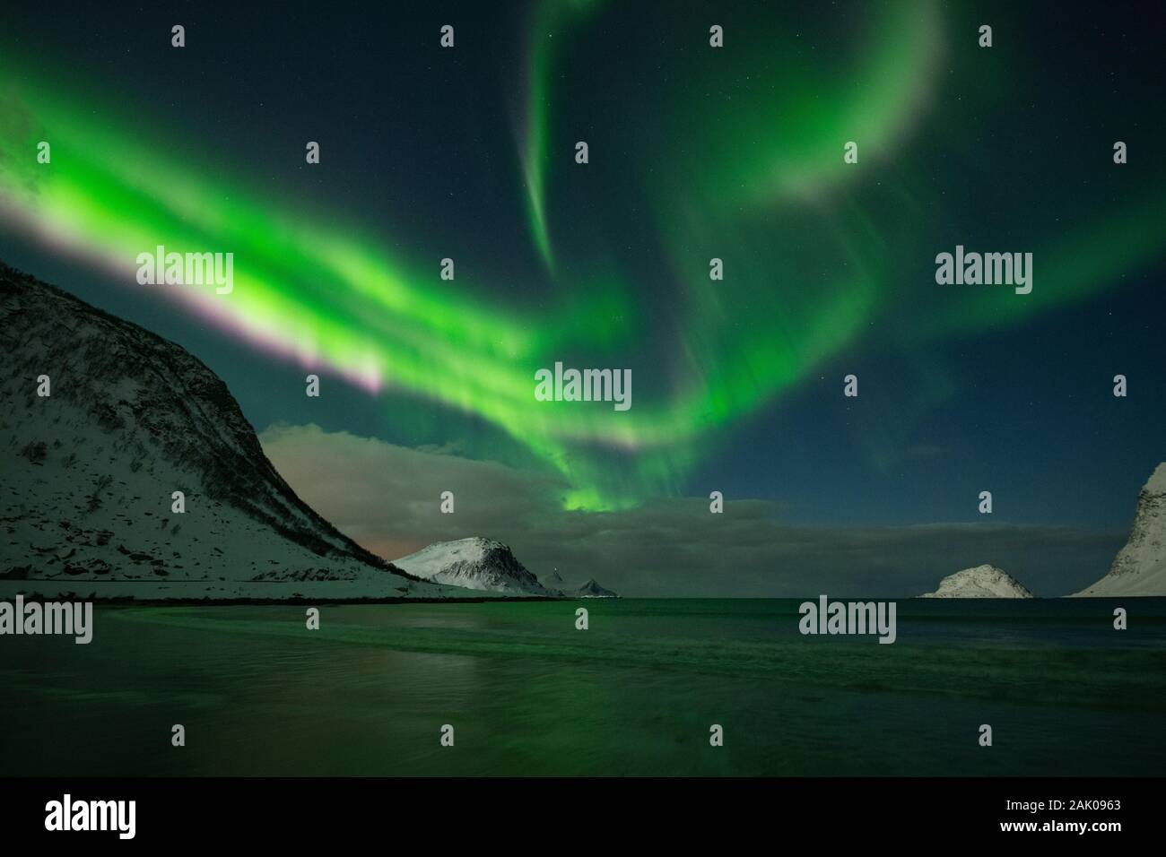 Northern Lights - Aurora Borealis fill sky over snow covered mountains ...