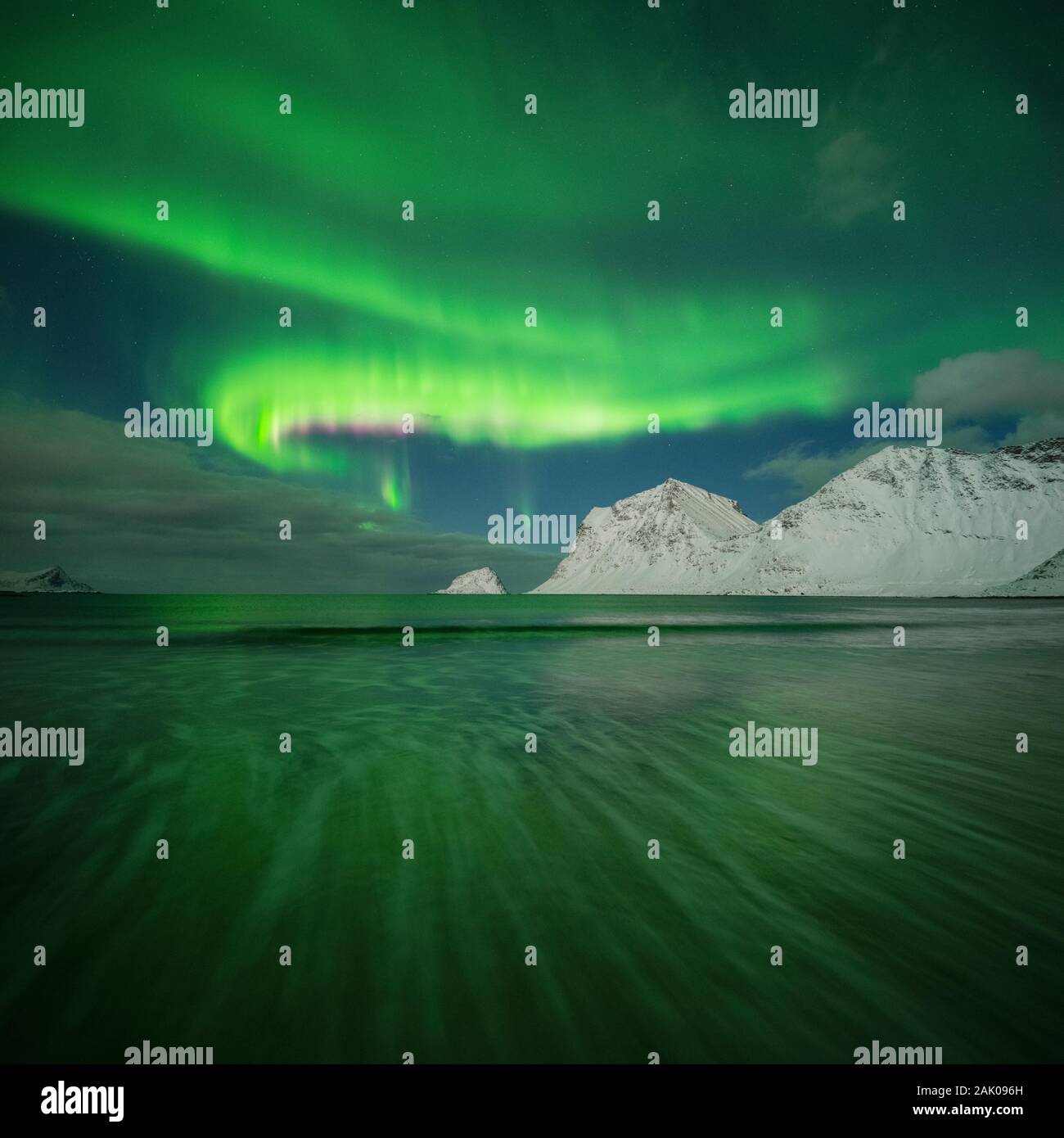Northern Lights - Aurora Borealis fill sky over snow covered mountains ...