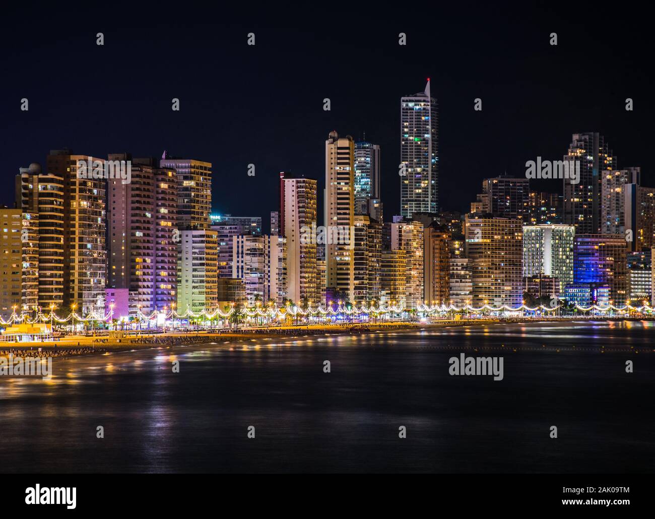 Night skyline of Benidorm with many lights from the skyscrapers ...