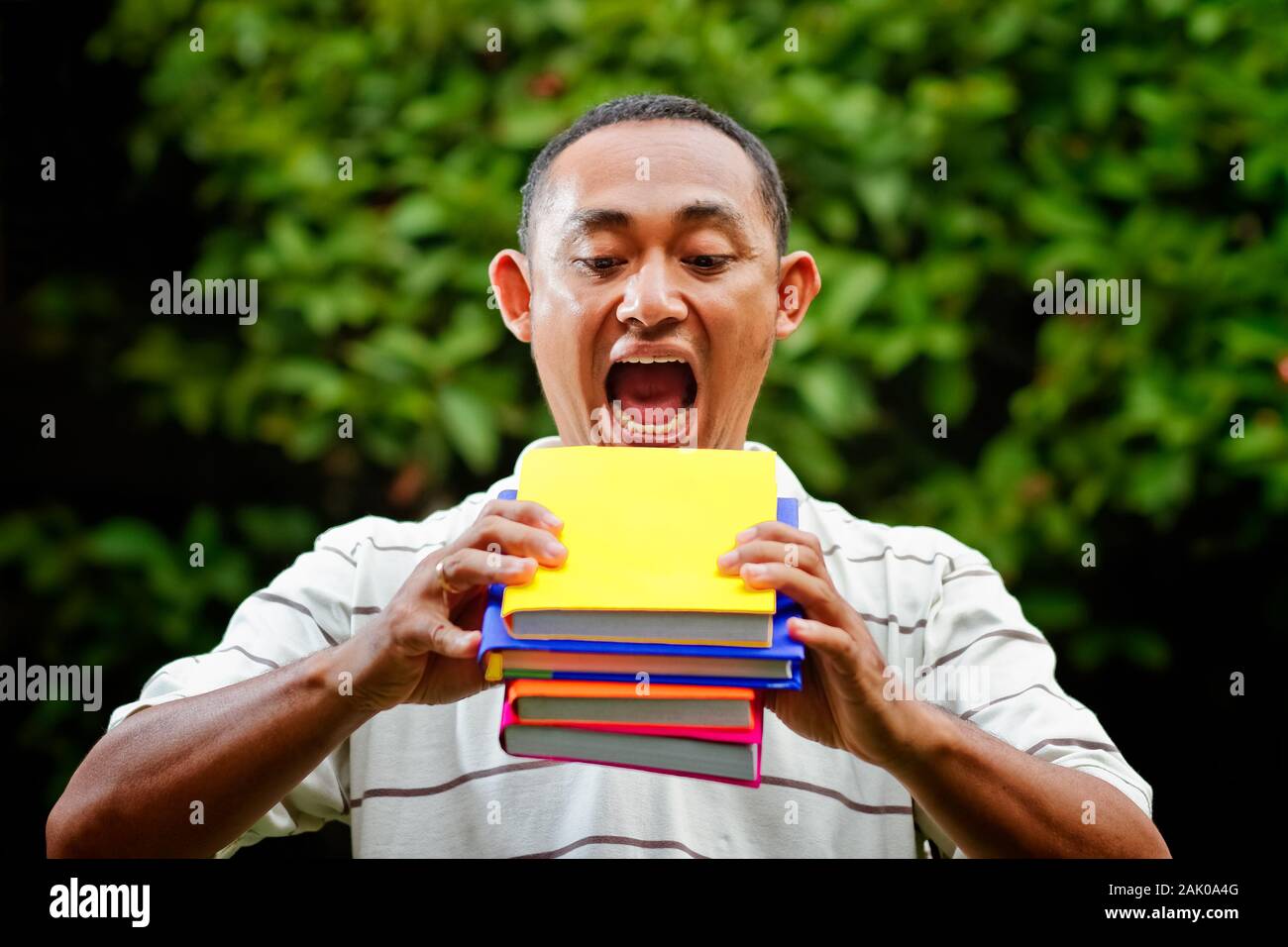 ethnic asian male student hungry of knowledge education Stock Photo - Alamy