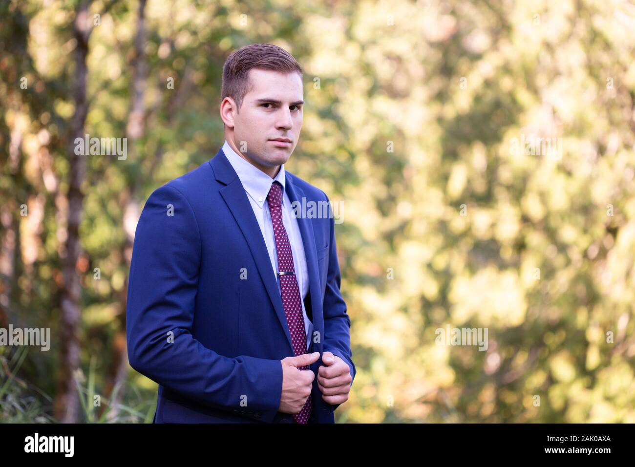 Serious young man in business suit stares down camera in PNW Stock ...