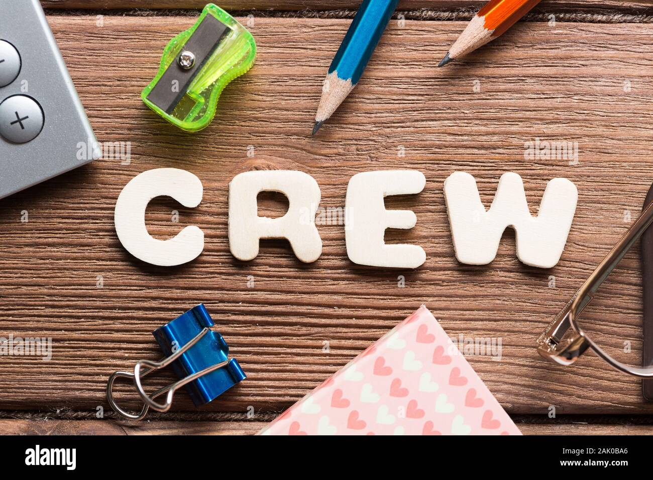 Crew word on wooden table and office stationary around Stock Photo - Alamy