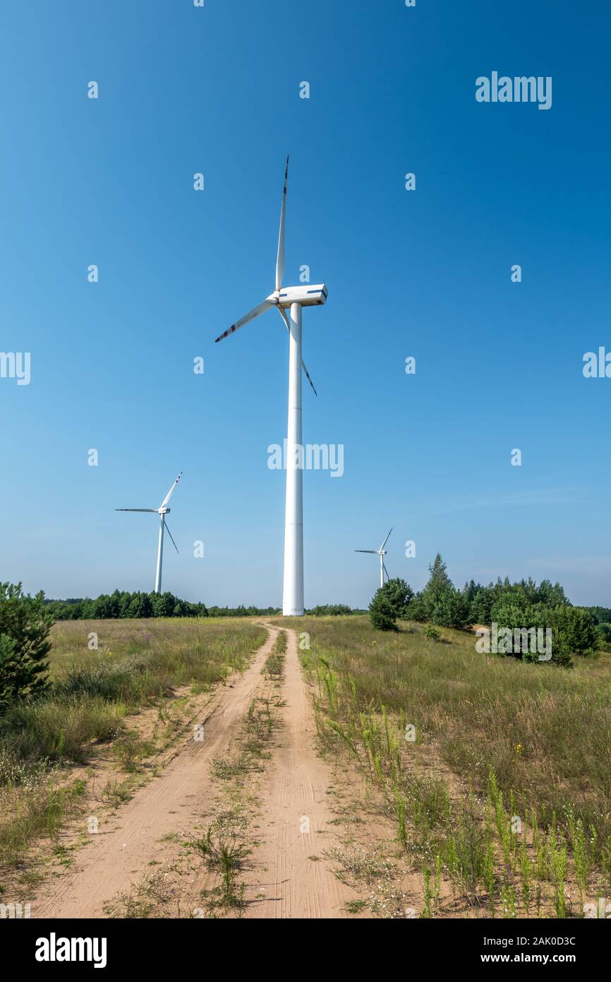 rotating blades of a windmill propeller on blue sky background. Wind ...
