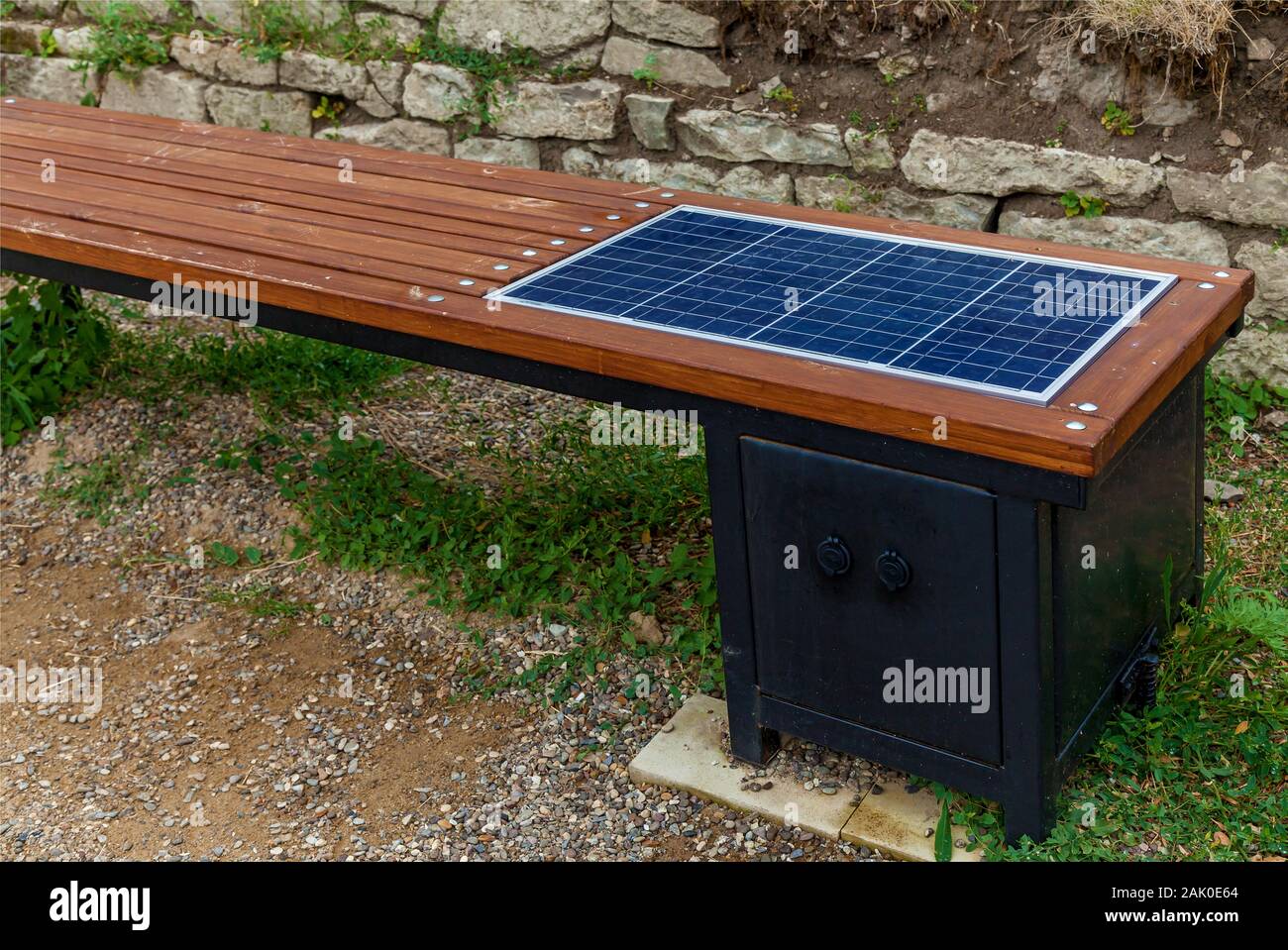 A modern bench for charging phones and tablets on the background of the ...