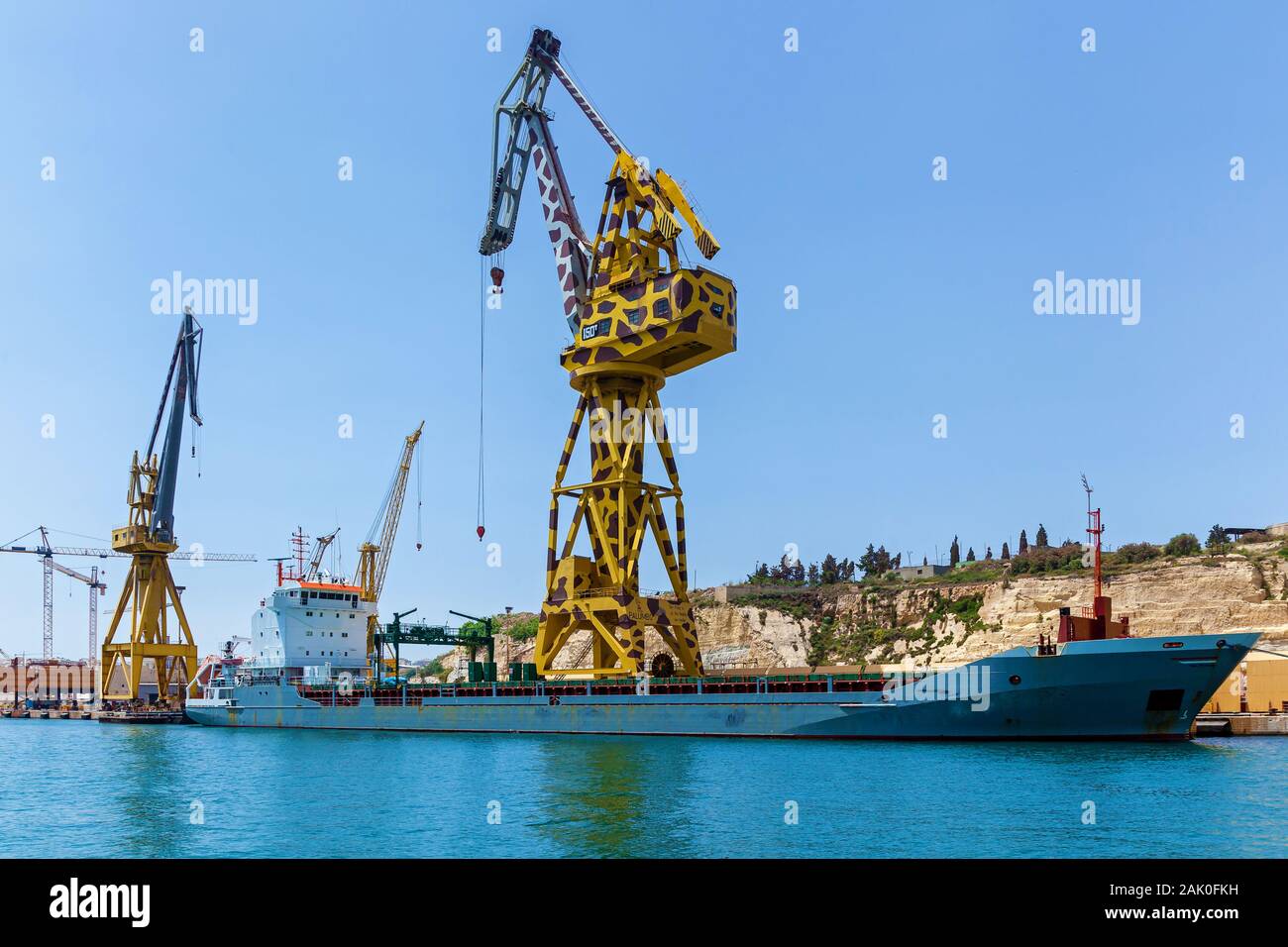 Colorful crane is placed on a floating dock in the harbor, Malta ...