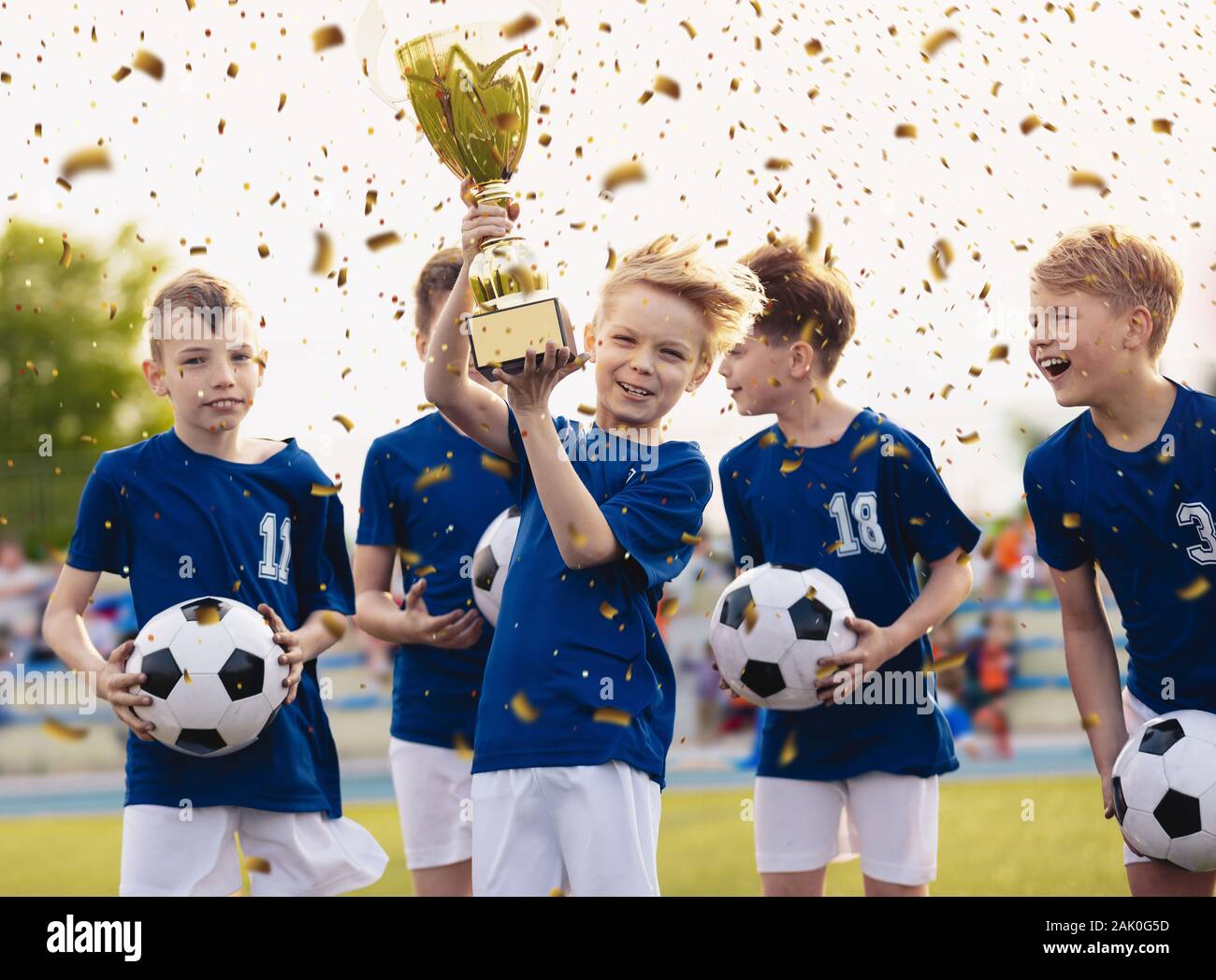 Happy kids in elementary school sports team celebrating soccer success ...