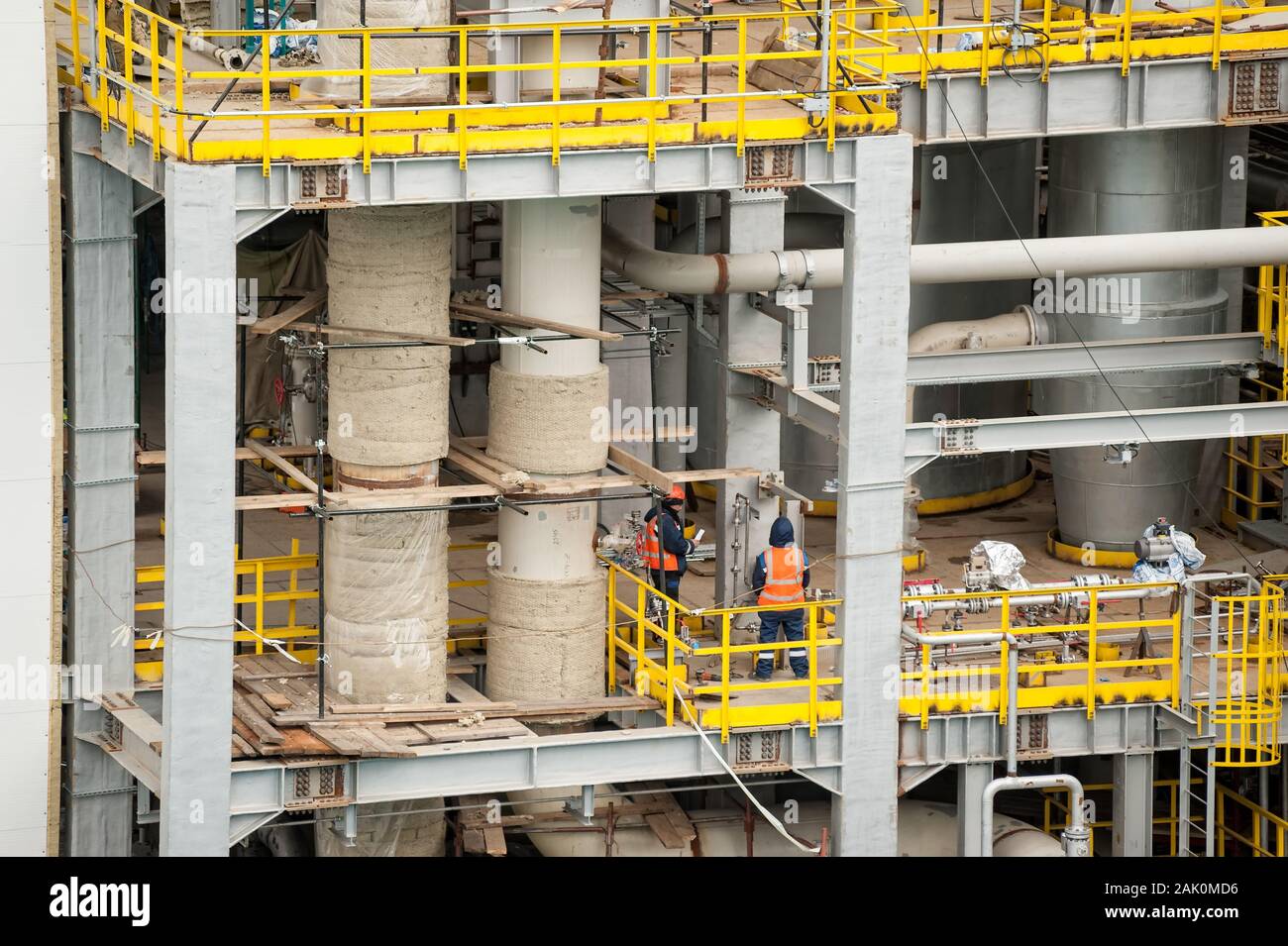 Workers on construction site of gas factory Stock Photo - Alamy