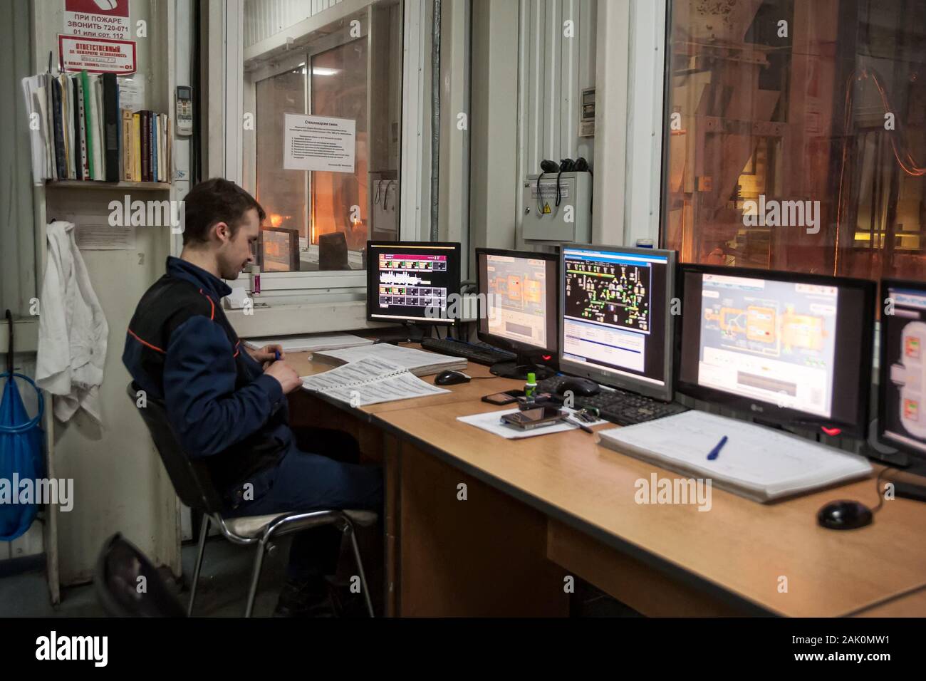 Engineer in control room of glass factory. Tyumen Stock Photo - Alamy