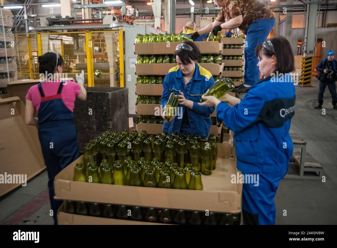 Women choosing and packing empty bottles Stock Photo - Alamy
