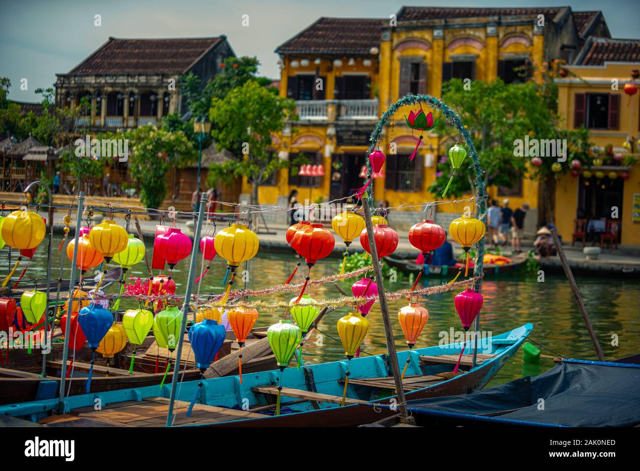 Traditional wooden Vietnamese boat decorated with lanterns along the ...