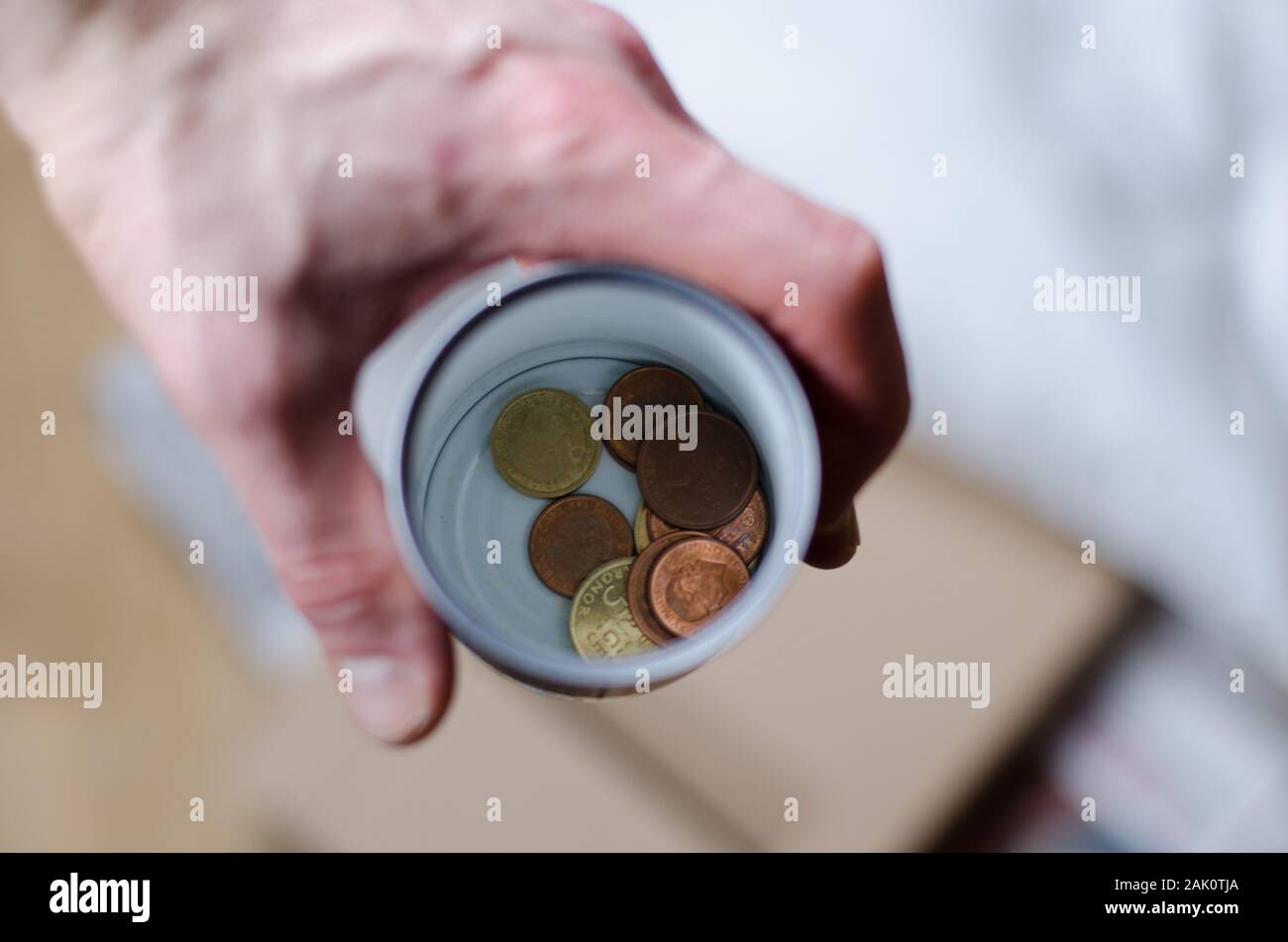Begging cup hi-res stock photography and images - Alamy