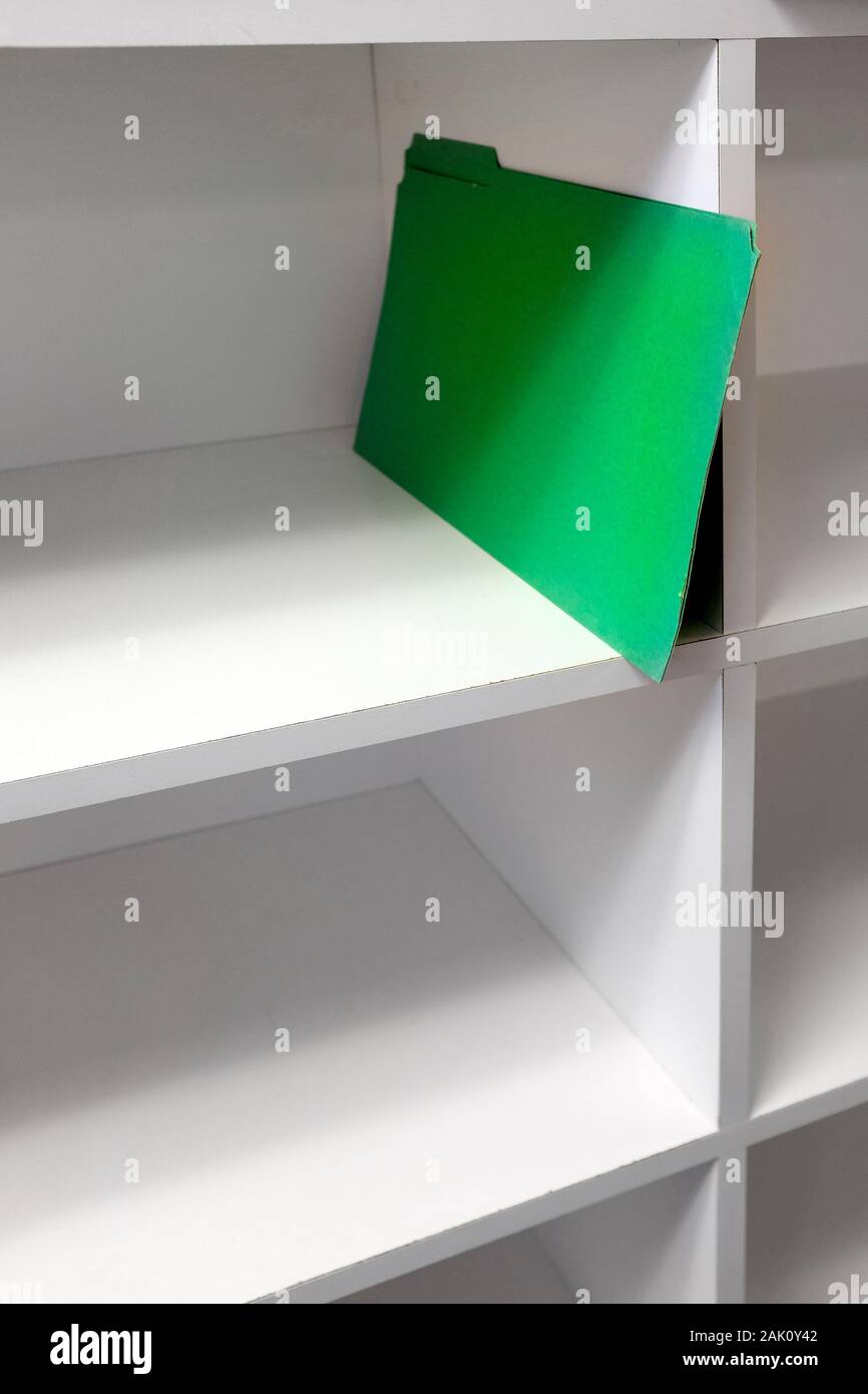 Green file folder on shelf for business organization symbolizing ...