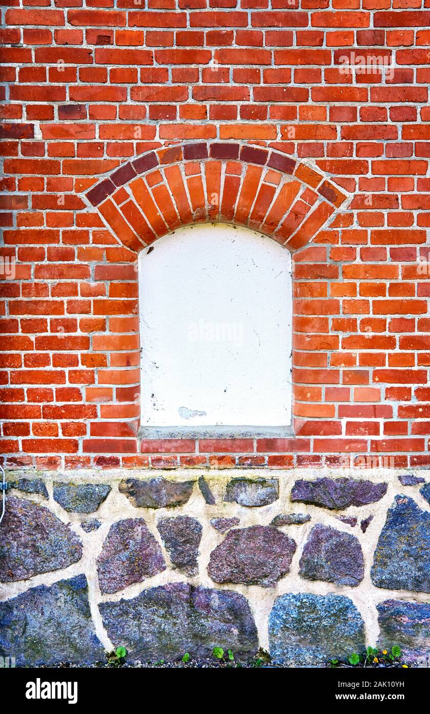 White window with space for text on a brick and natural stone wall ...