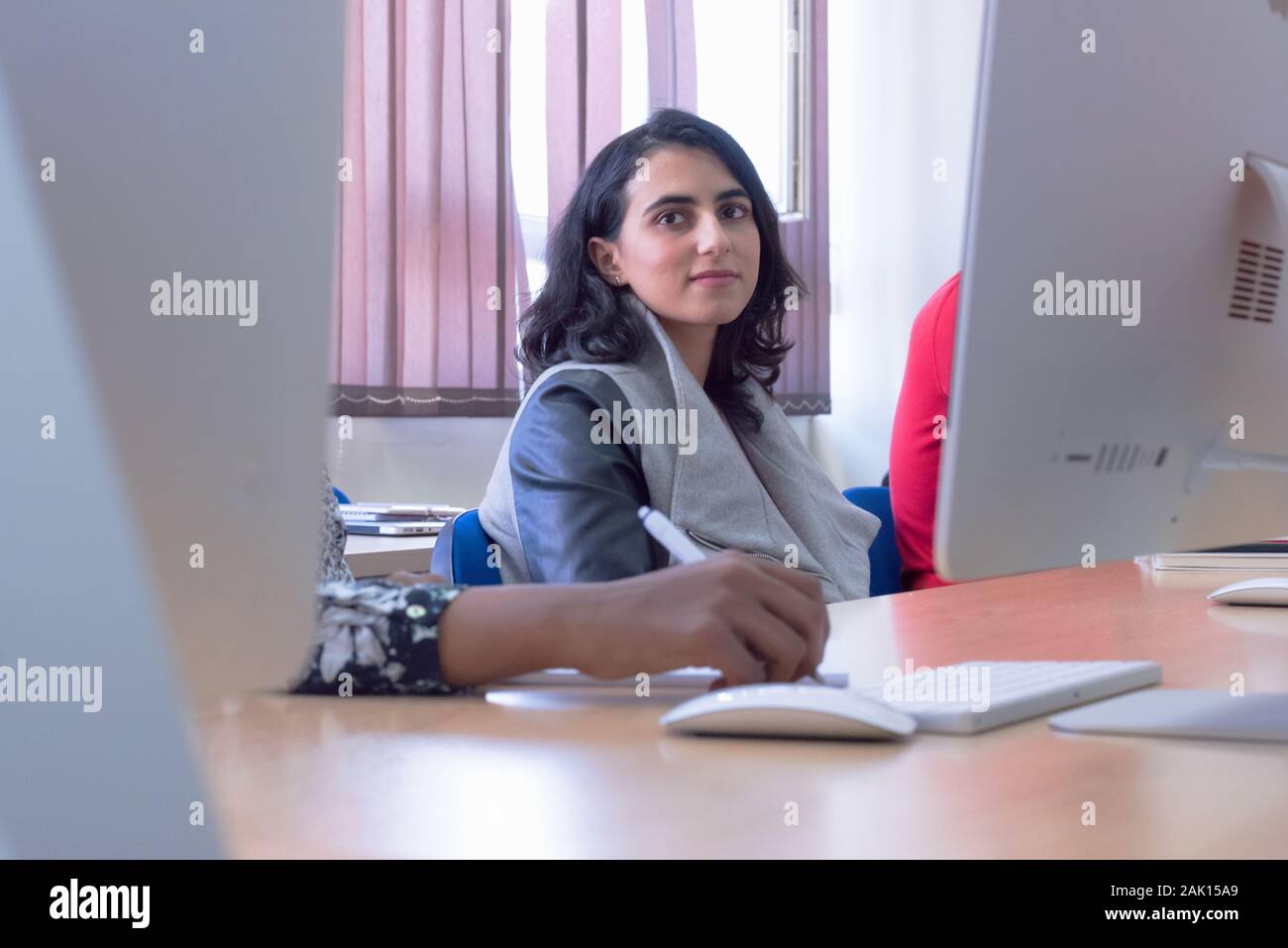 Beautiful female middle eastern IT student working at her computer lab ...