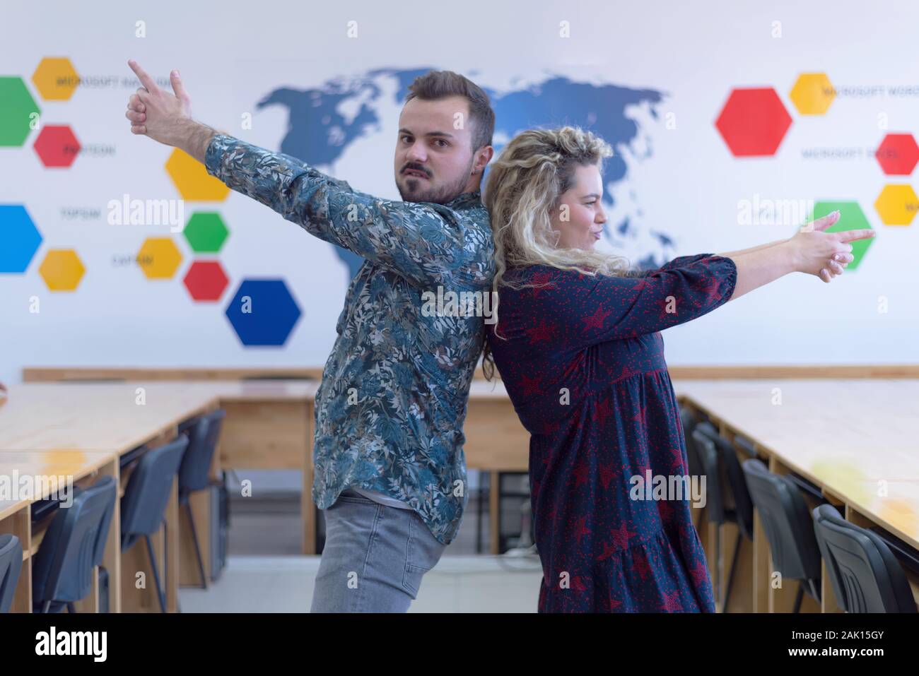 Two college students standing inside classroom and laughing after ...