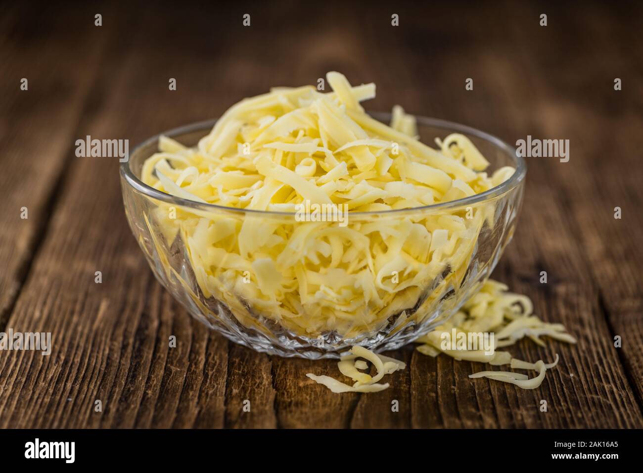Old wooden table with grated Cheese (close-up shot Stock Photo - Alamy