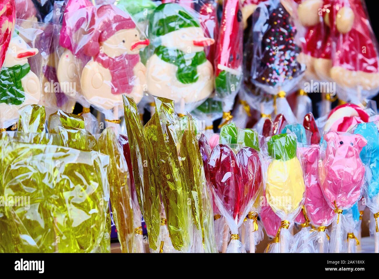 Lots of packaged sweets. Lollipops, candy in different figurines. Close ...