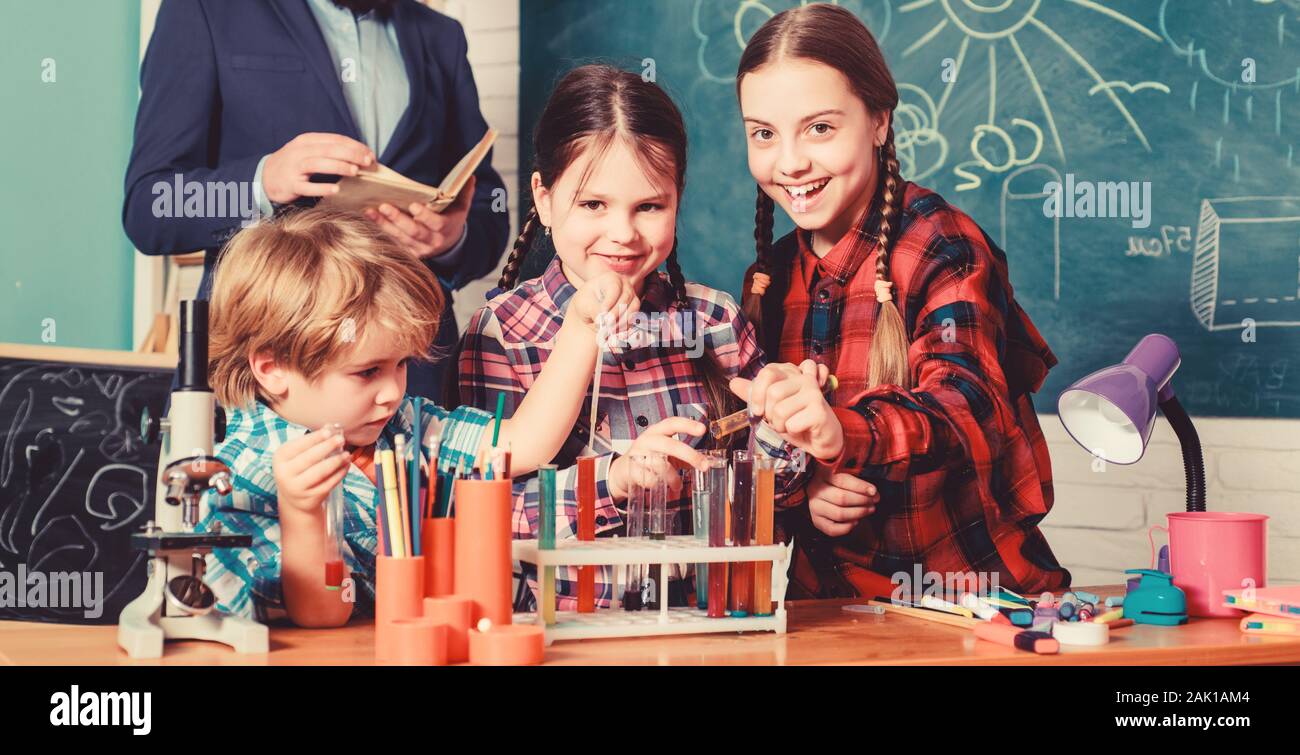 doing experiments with liquids in chemistry lab. children making ...