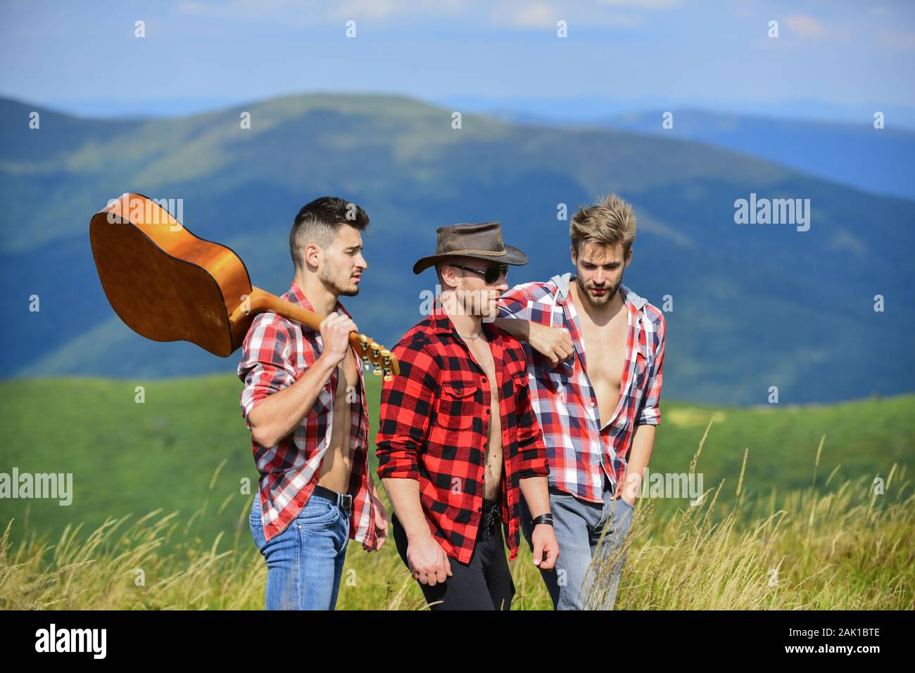 music band. happy men friends with guitar. friendship. hiking adventure ...