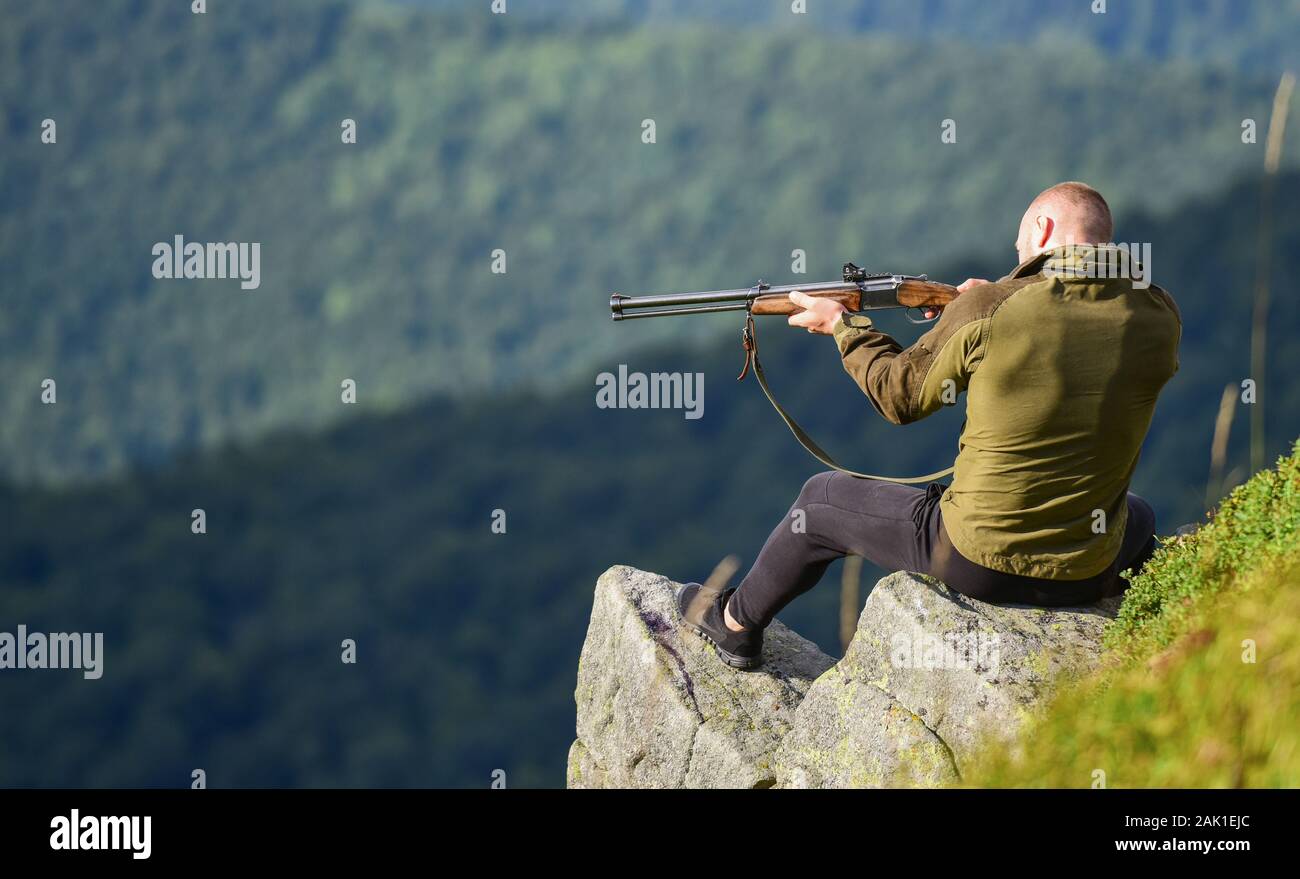 Hunter hold rifle. Hunter spend leisure hunting. Man brutal gamekeeper ...
