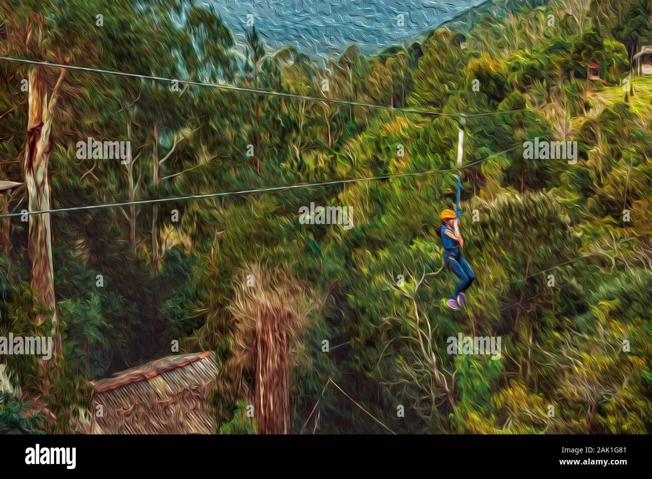 Little girl descending by cables in a sport called zip-line in a valley ...