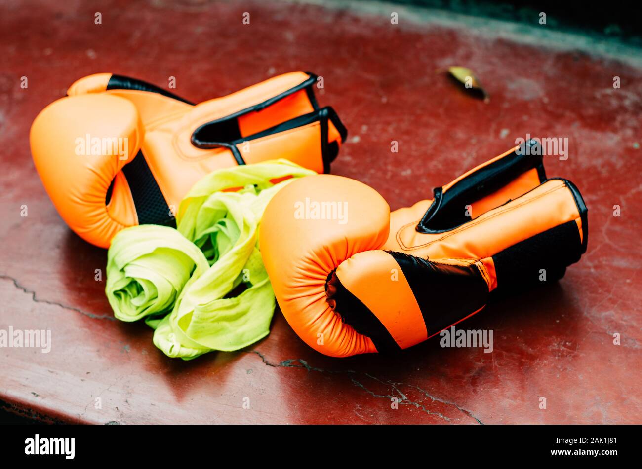 orange boxing gloves on the ring floow Stock Photo - Alamy