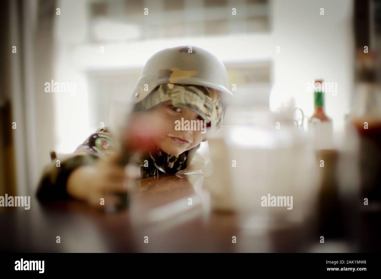 Boy in army outfit pointing gun Stock Photo - Alamy