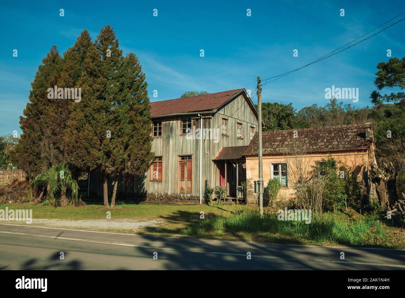 Old wooden and masonry houses in a traditional rural style with lawn ...