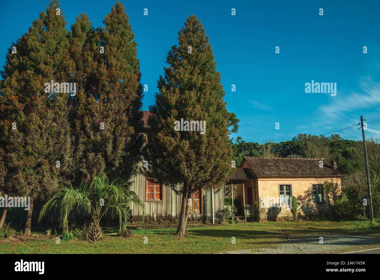 Old wooden and masonry houses in a traditional rural style with lawn ...
