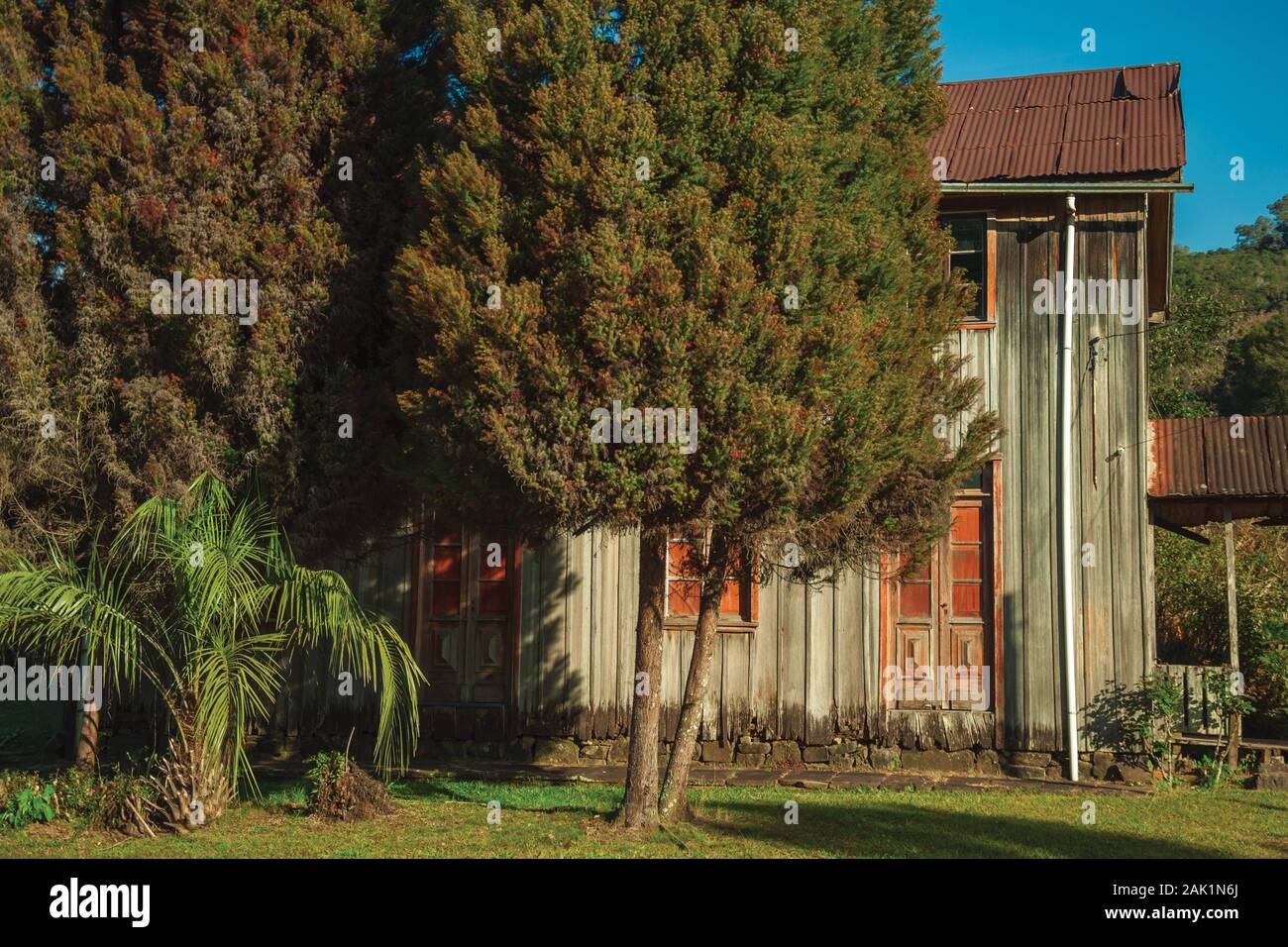 Old wooden and masonry houses in a traditional rural style with lawn ...