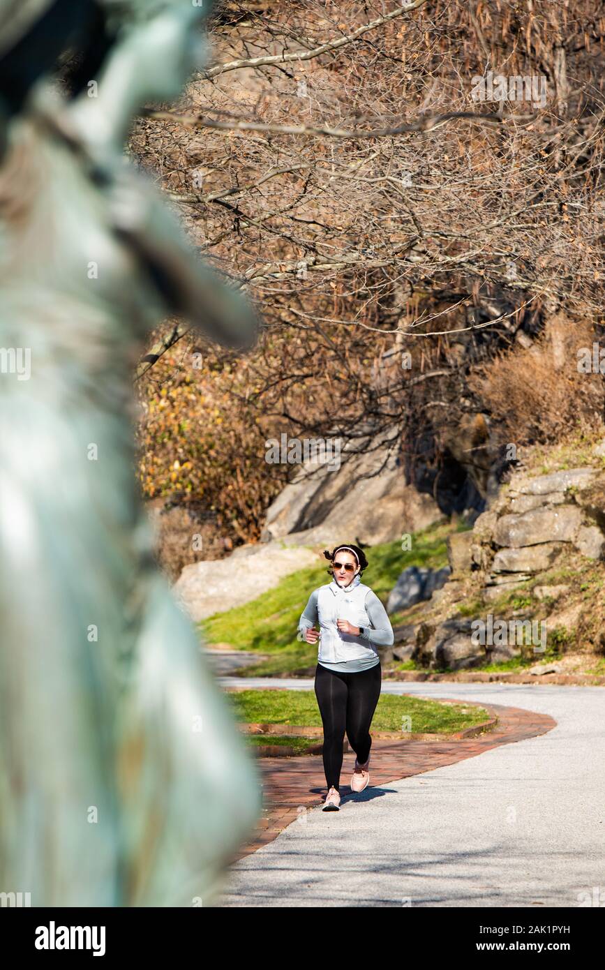 A woman runs towards a statue representation of the greek myth Leda and ...