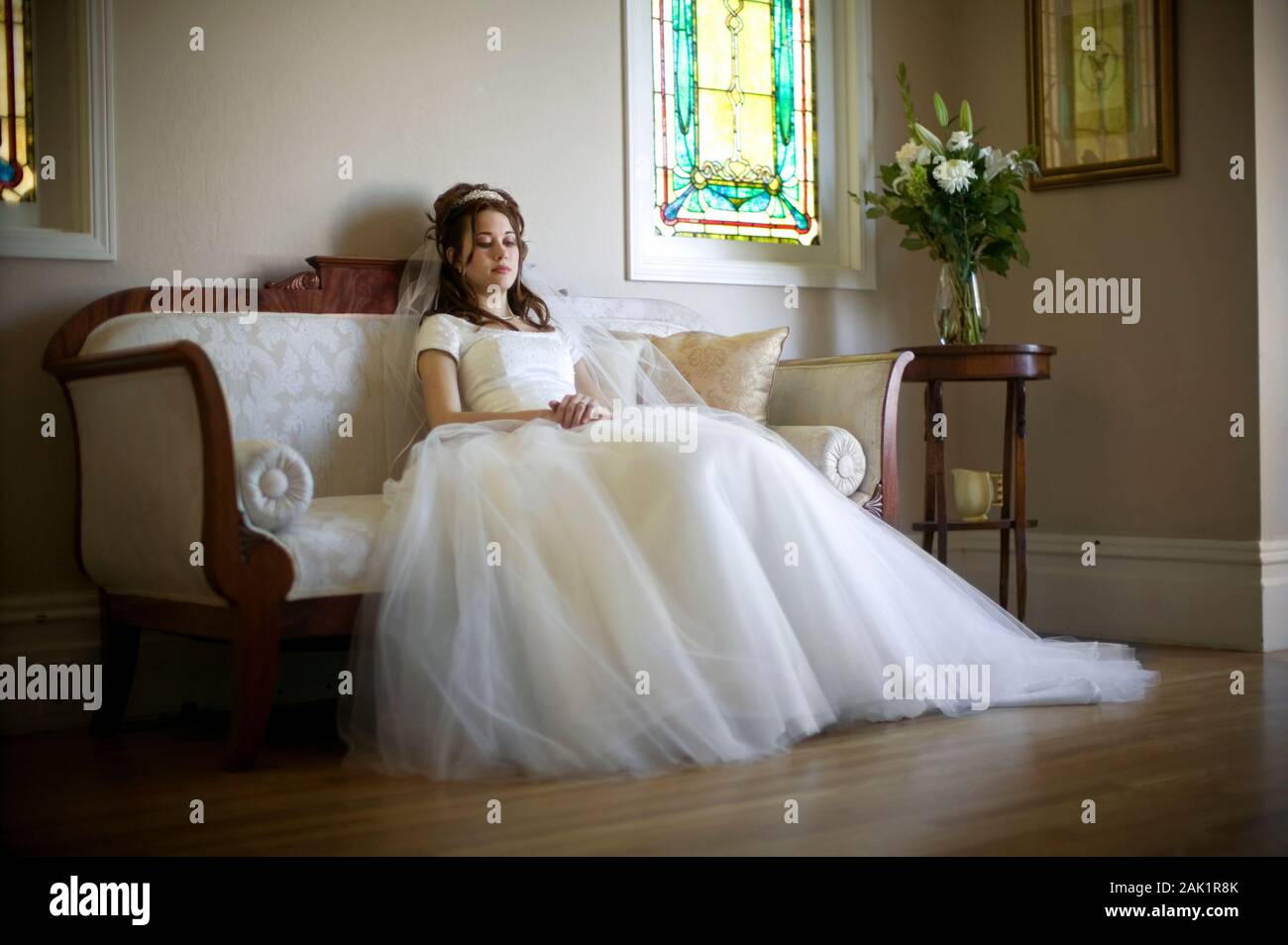 Young bride sitting in her wedding dress Stock Photo - Alamy