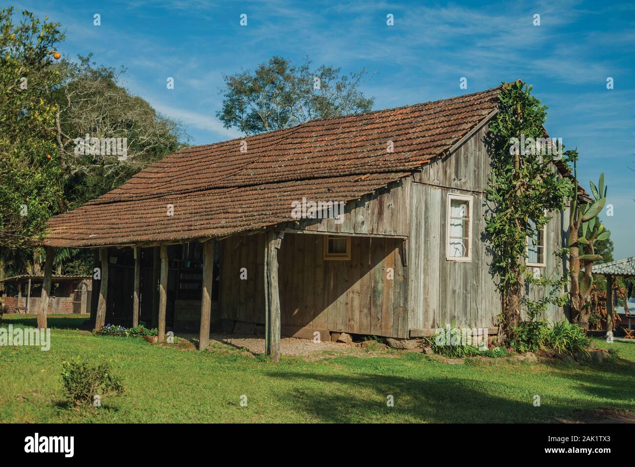 Old shack made of wood in a traditional rural style with lush ...
