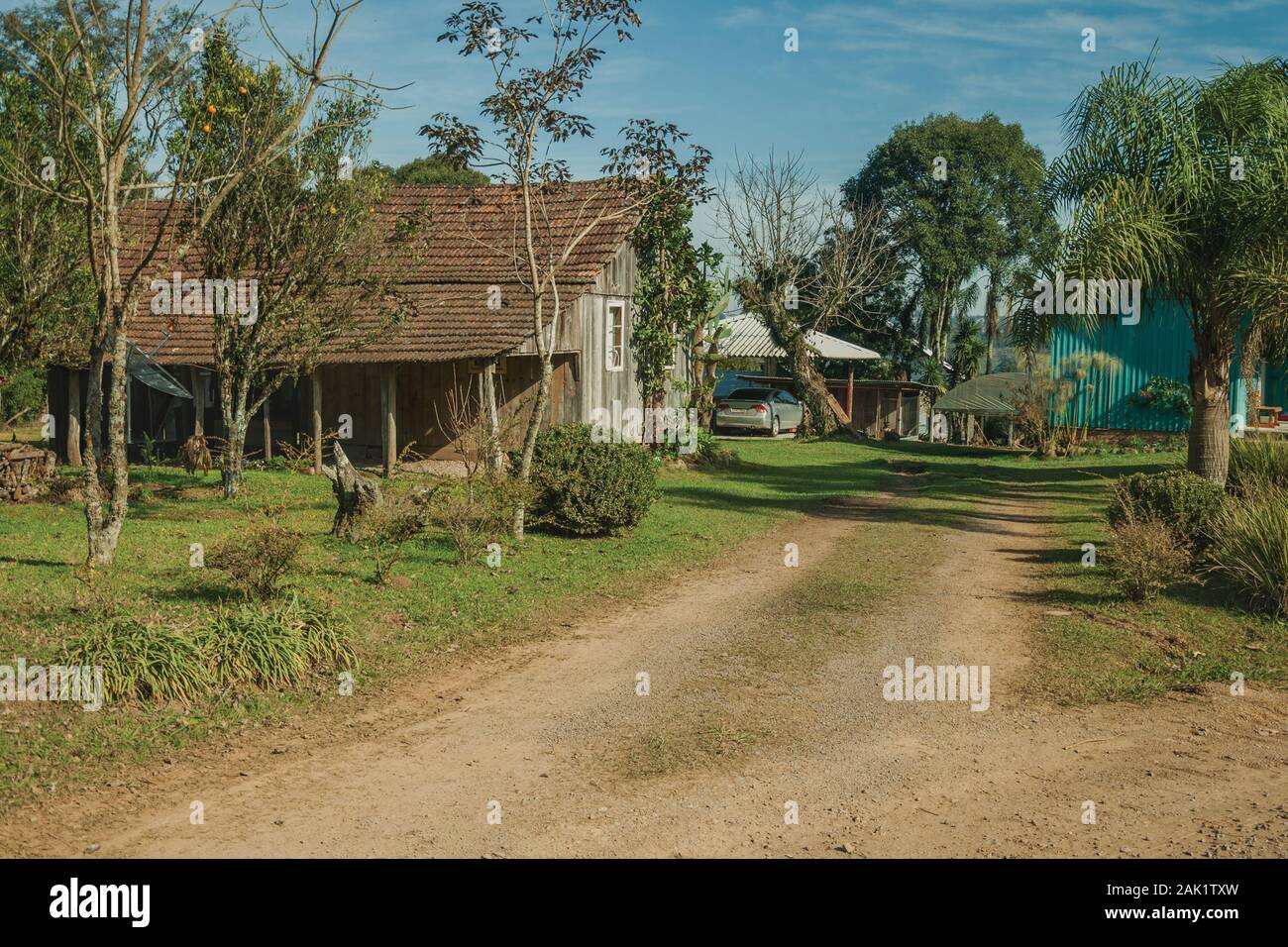 Old shack made of wood in a traditional rural style with lush ...