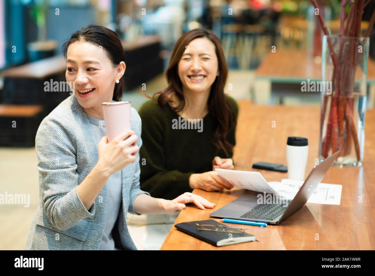 Two women in coworking office Stock Photo - Alamy