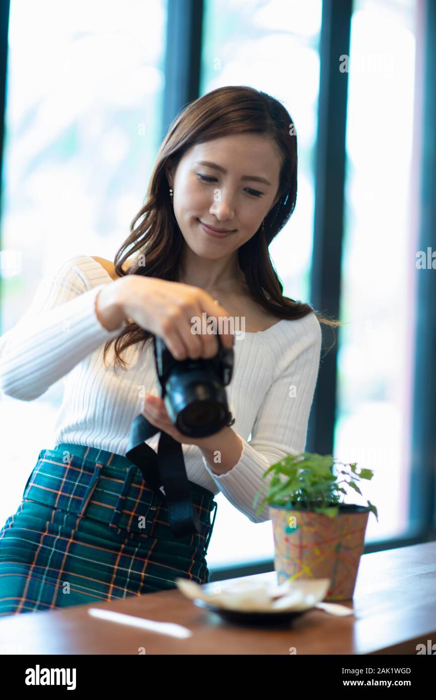 Woman taking photo Stock Photo - Alamy