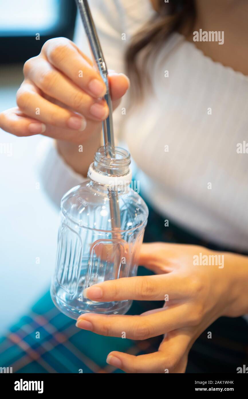 Reusable straw and plastic bottle Stock Photo - Alamy
