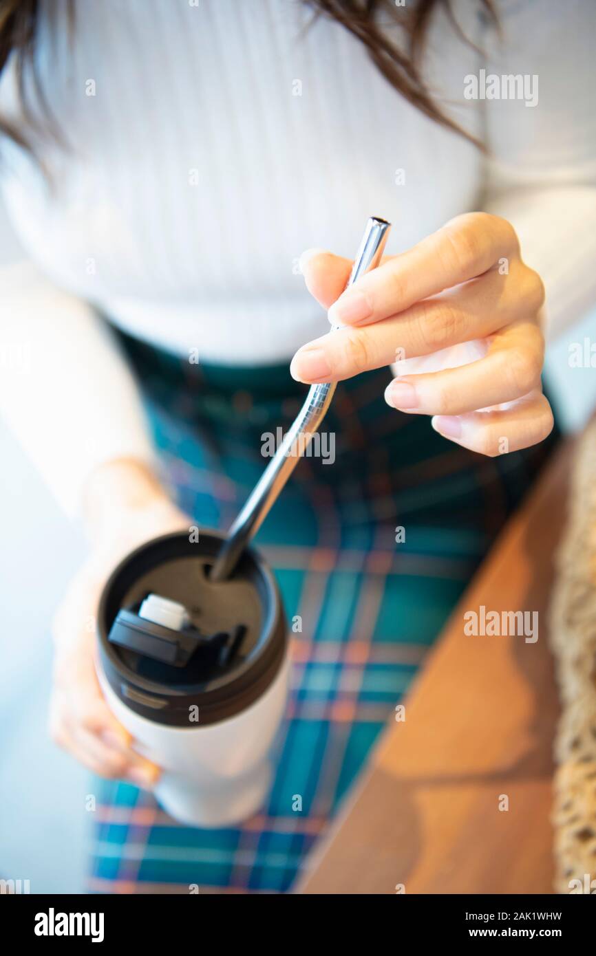 Woman using reusable straw Stock Photo - Alamy