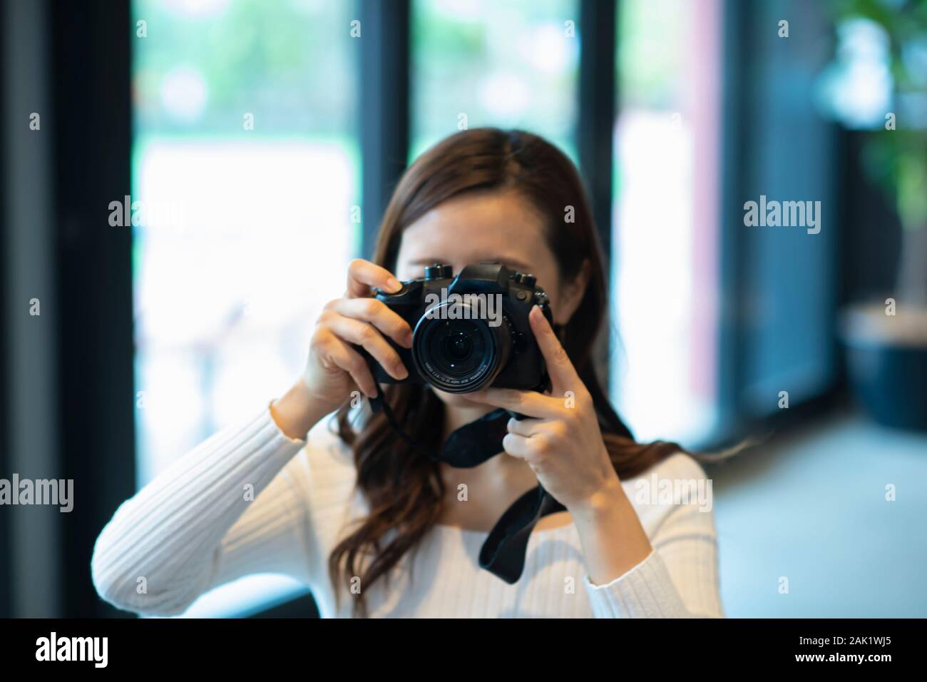 Woman taking photo Stock Photo - Alamy
