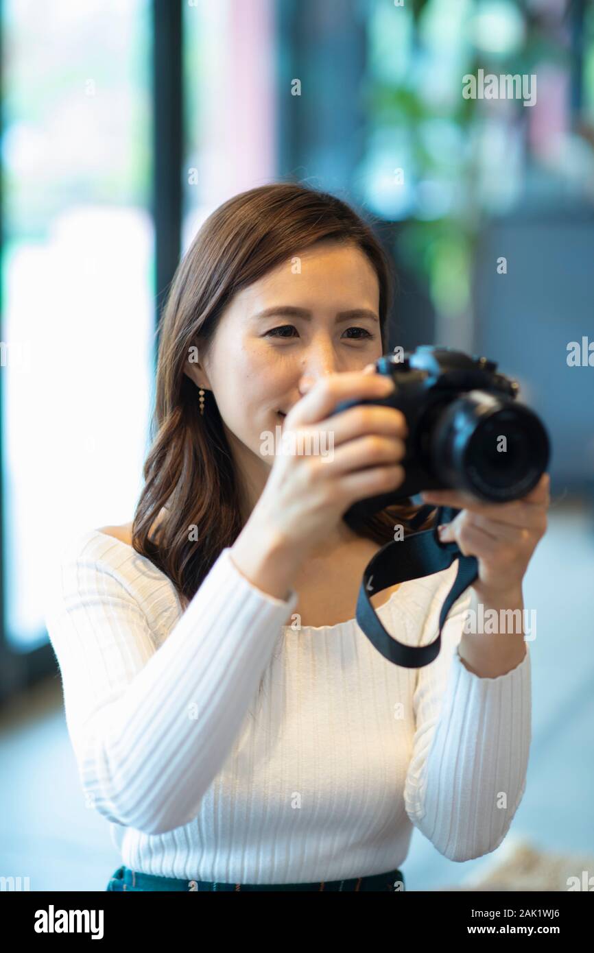Woman taking photo Stock Photo - Alamy