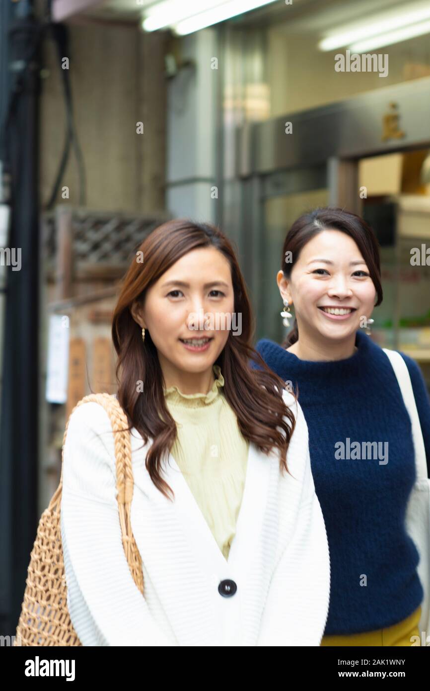 Women walking through town Stock Photo - Alamy