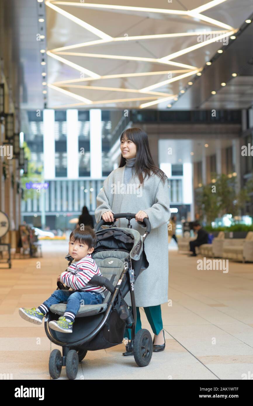 Female commuter with child Stock Photo - Alamy