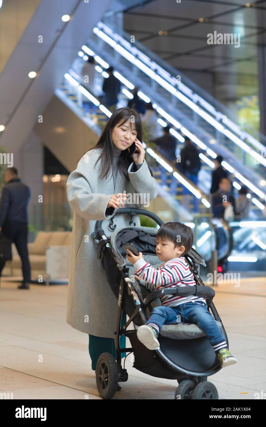 Female commuter with child Stock Photo - Alamy