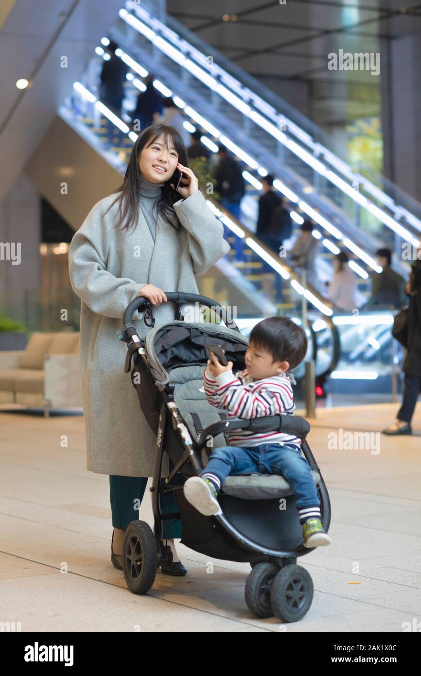 Female commuter with child Stock Photo - Alamy